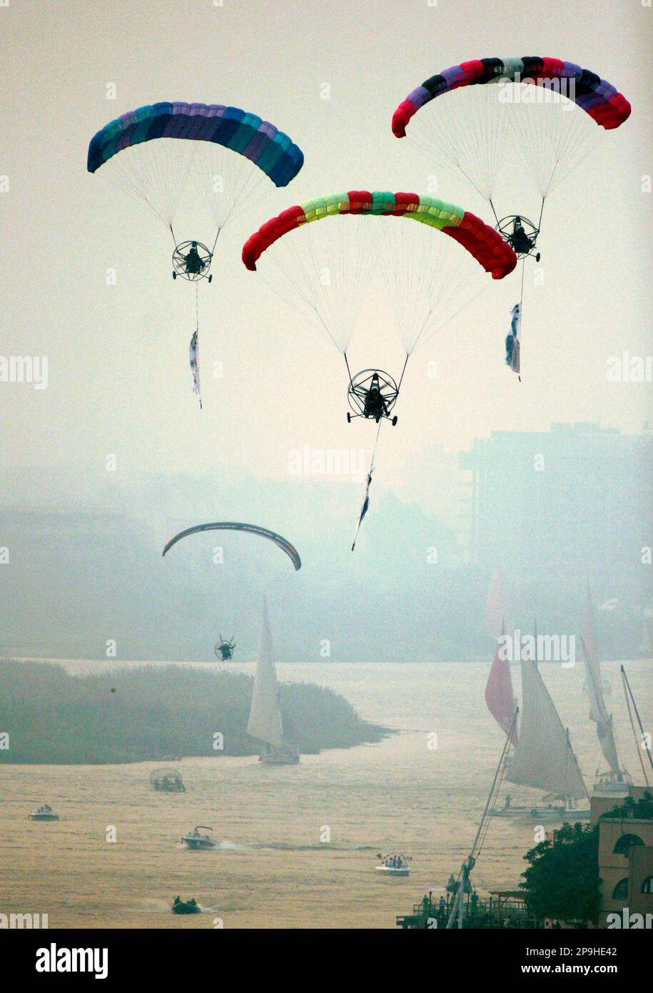 Egyptian military motorized paragliders perform over the river Nile ...