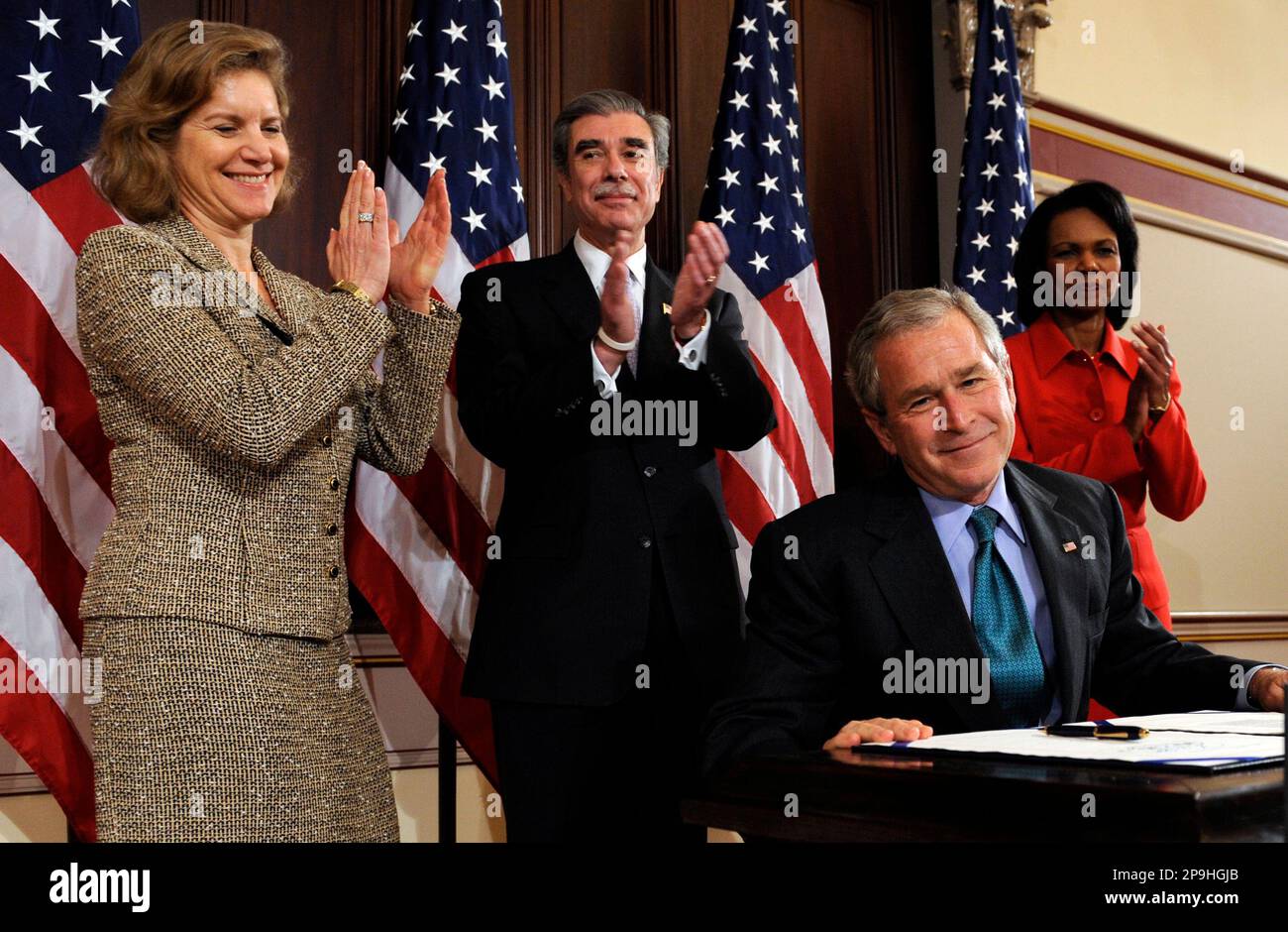 President Bush is applauded after signing the Andean Trade Preference ...