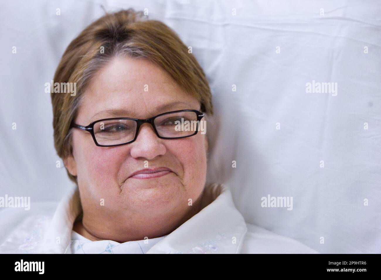 Cynthia Preloh, with her husband Brian Preloh, rests in her hospital ...