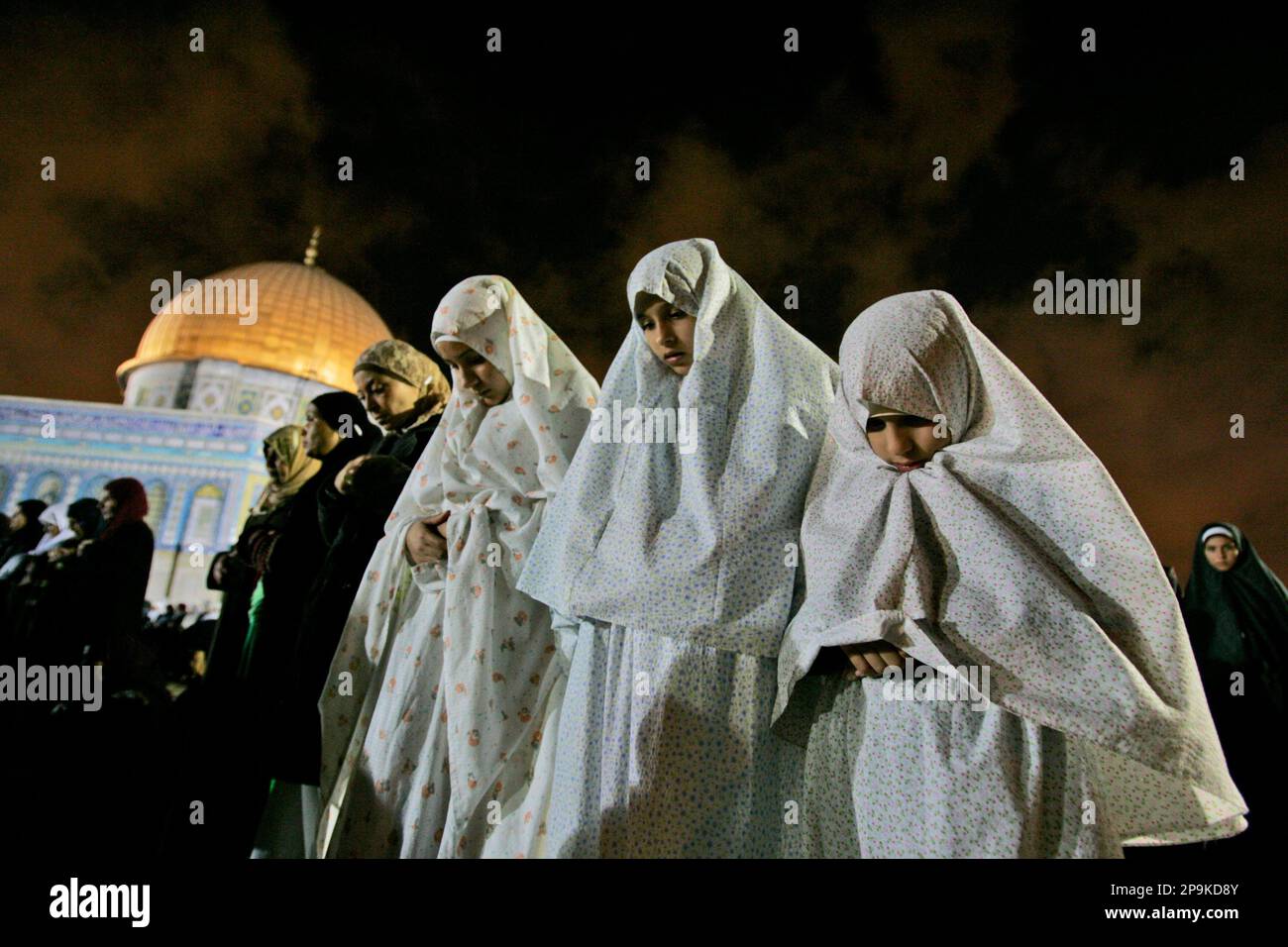 Female Palestinian Muslim worshipers pray during Lilat al-Qader, also ...