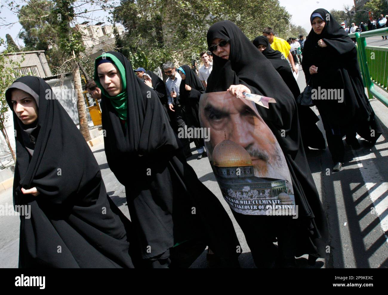 An Iranian female protestor holds a poster of Iranian late ...