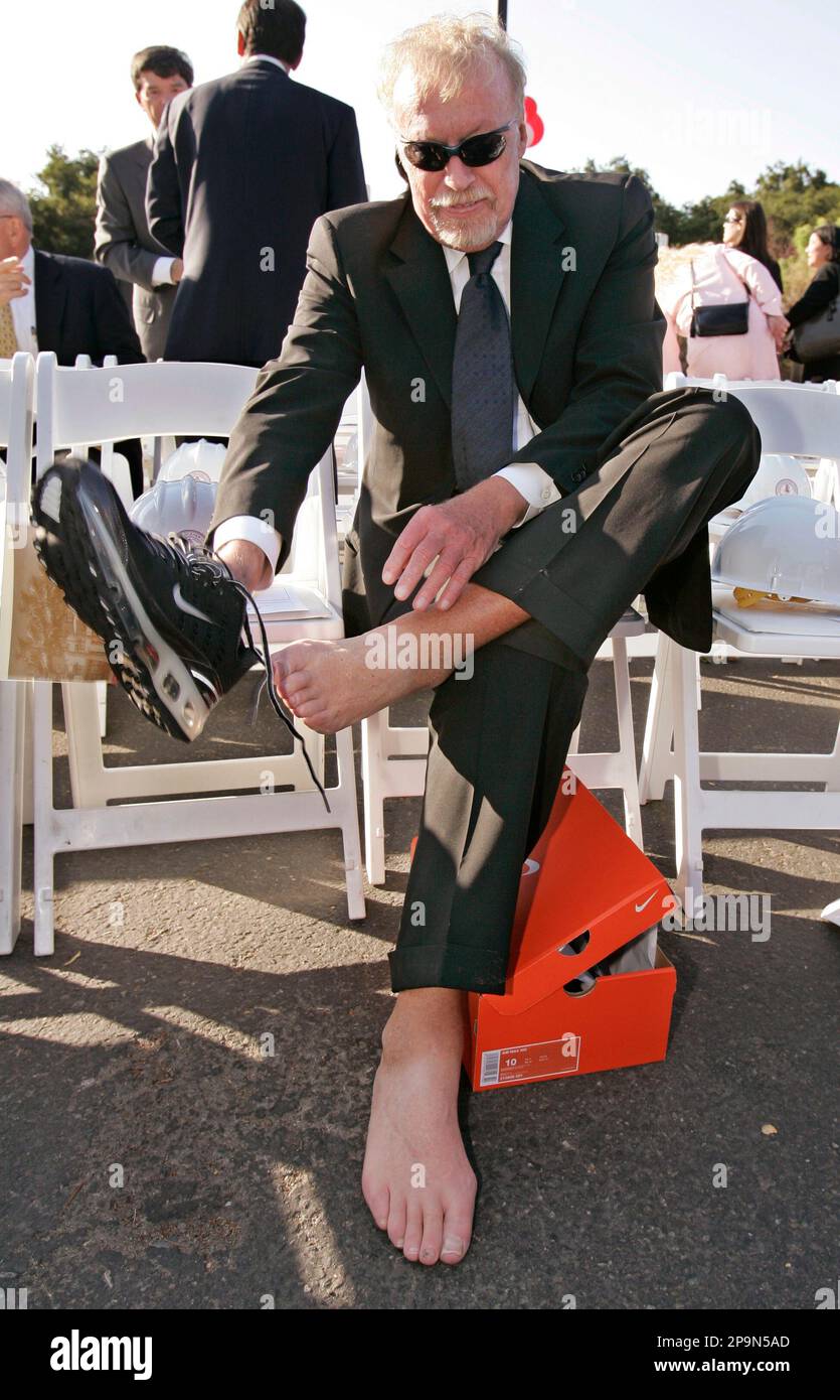 Nike founder and chairman Philip Knight changes shoes after he put his ...