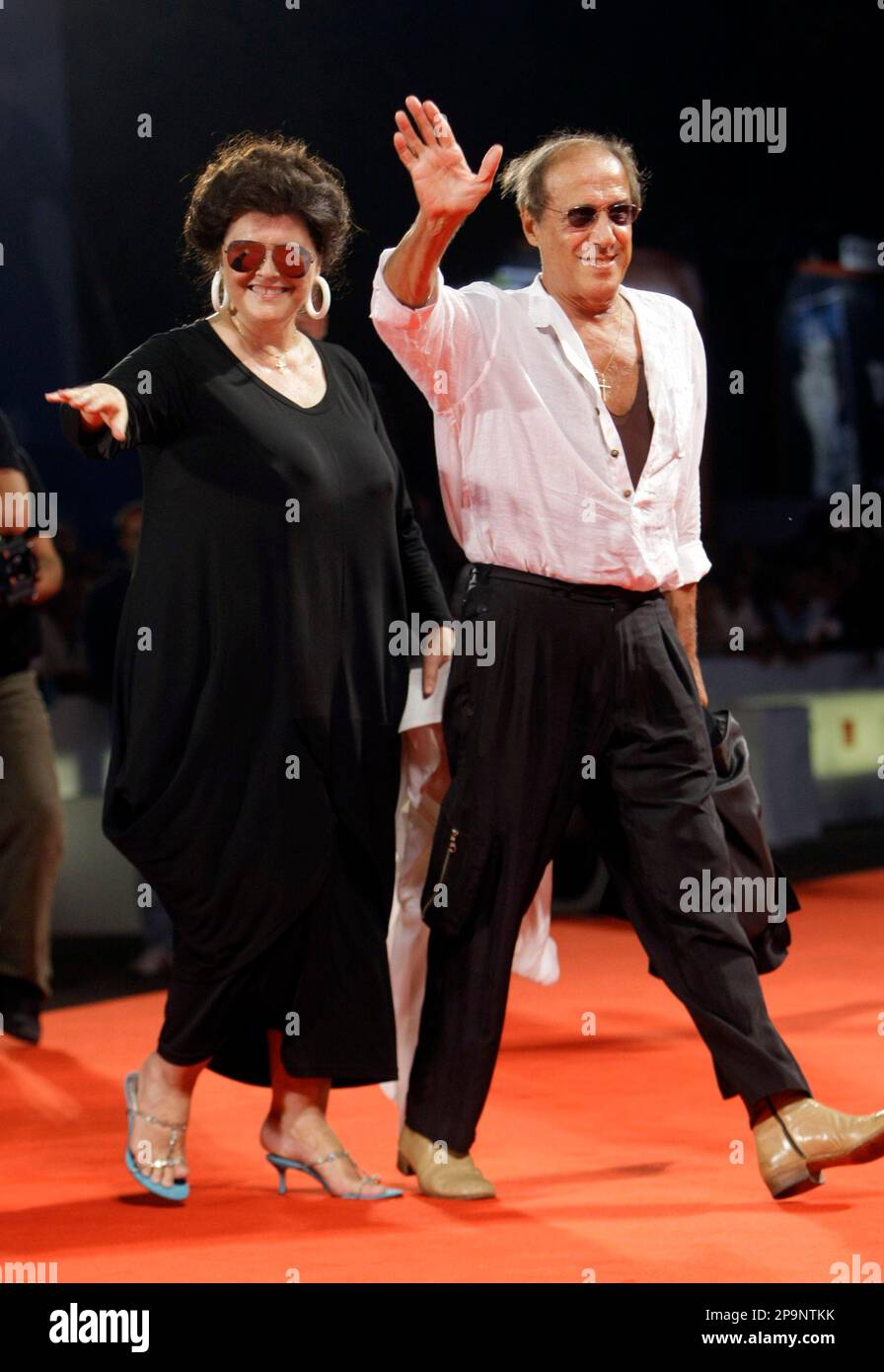 Showman Adriano Celentano, right, and his wife Claudia Mori arrive for ...