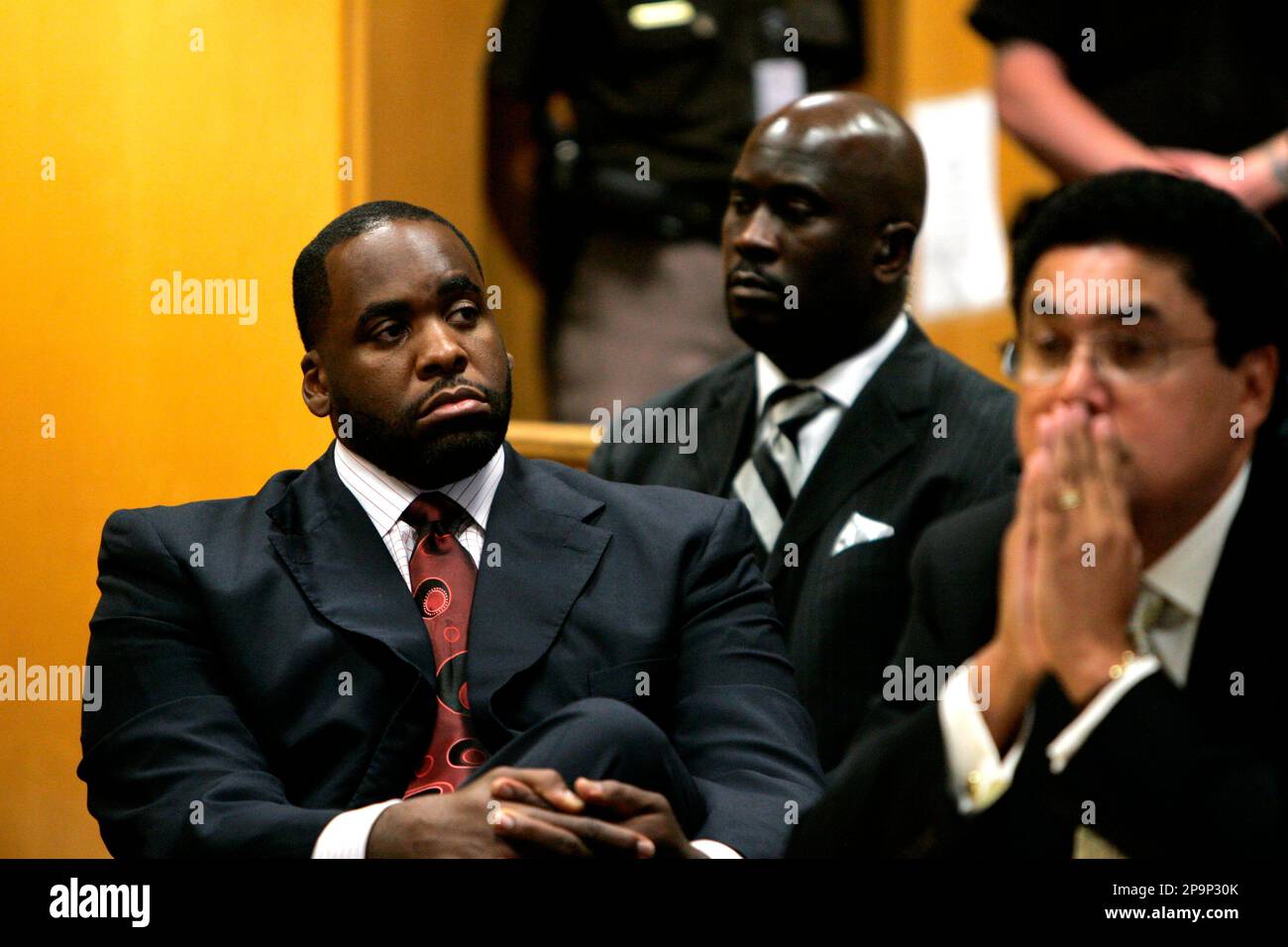 Detroit Mayor Kwame Kilpatrick, left, sits with his attorney Juan Mateo, right, in Wayne County ...