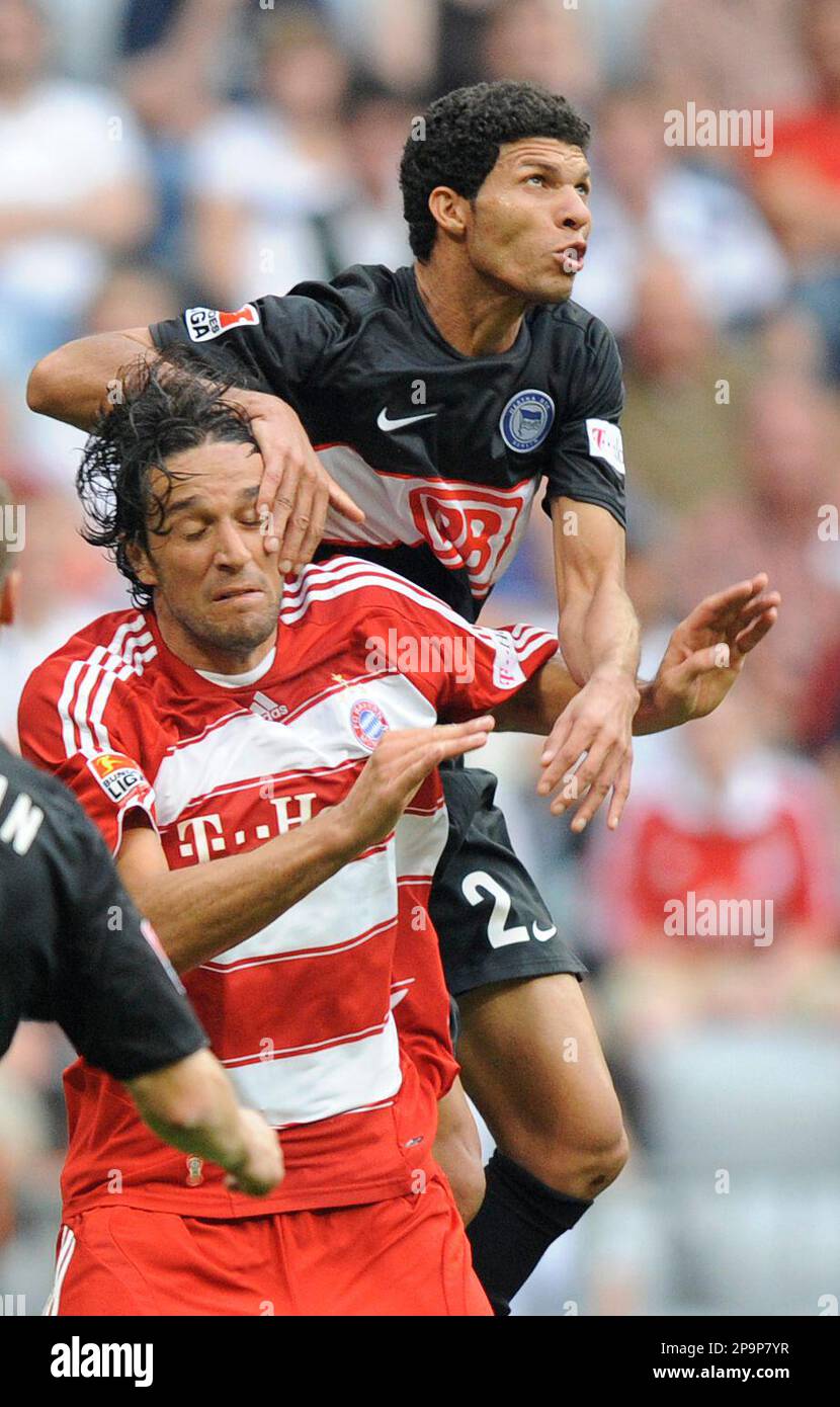 Munich player Luca Toni, left, is attacked by Berlin player Kaka, right ...