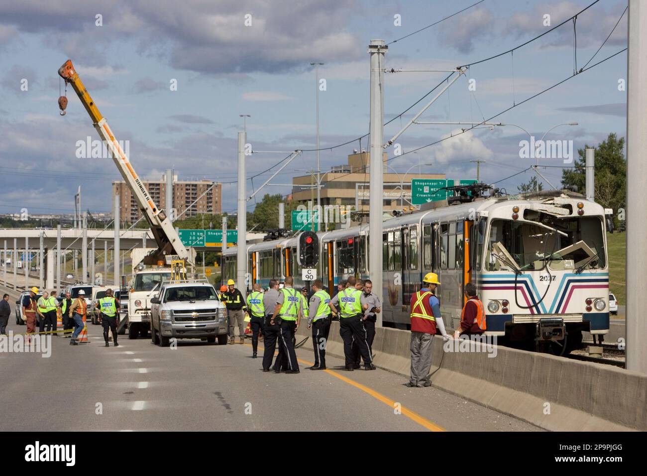 Police and transit workers investigate the scene of a Light Rapid ...