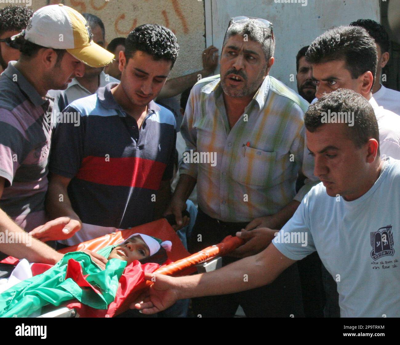 Palestinians carry the body of Ahmed Moussa, 10, fatally shot by ...