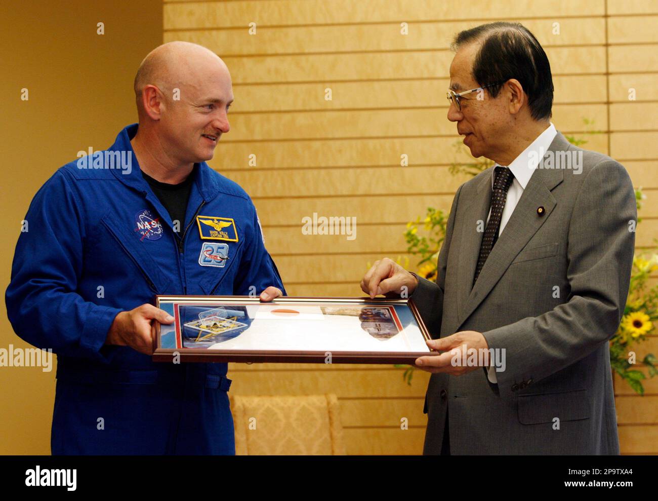 Space Shuttle Discovery Mission Commander Mark Kelly, left, explains ...