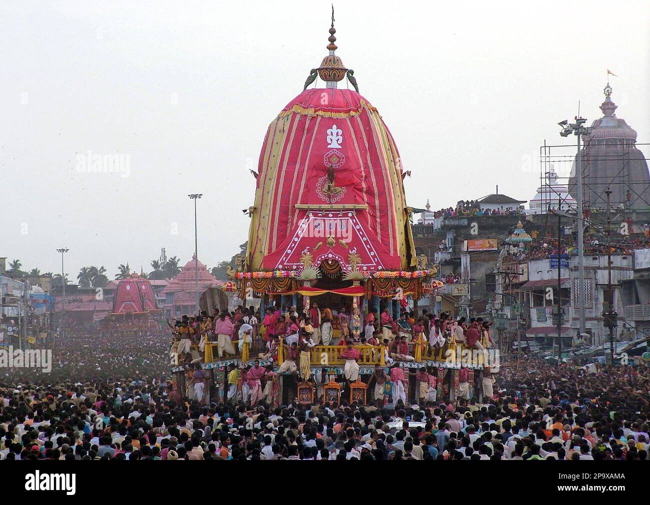 Devotees throng around decorated chariots outside the temple of ...