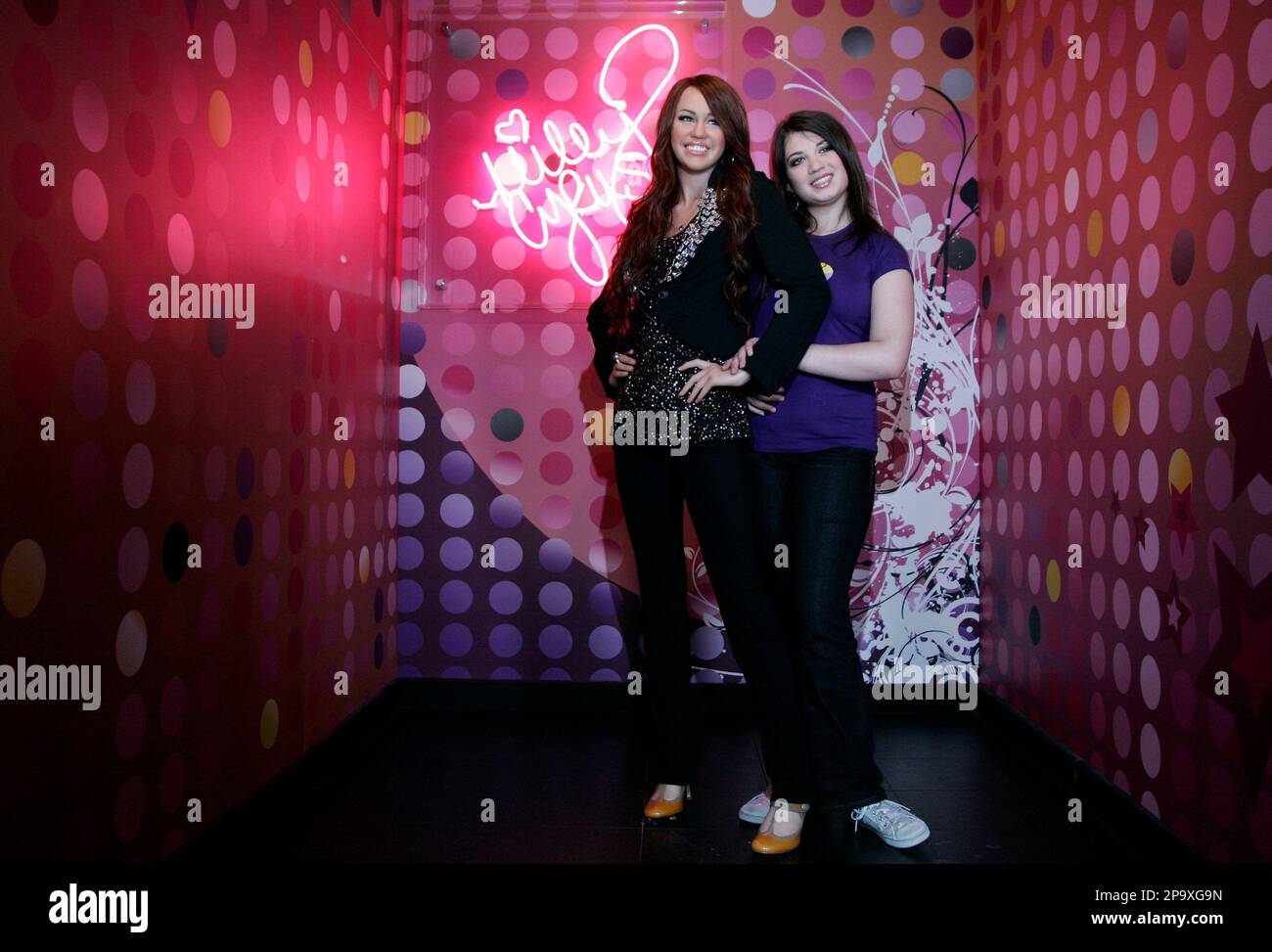 Sophie Dickson, right, a 13 year old British fan of Miley, poses with a ...