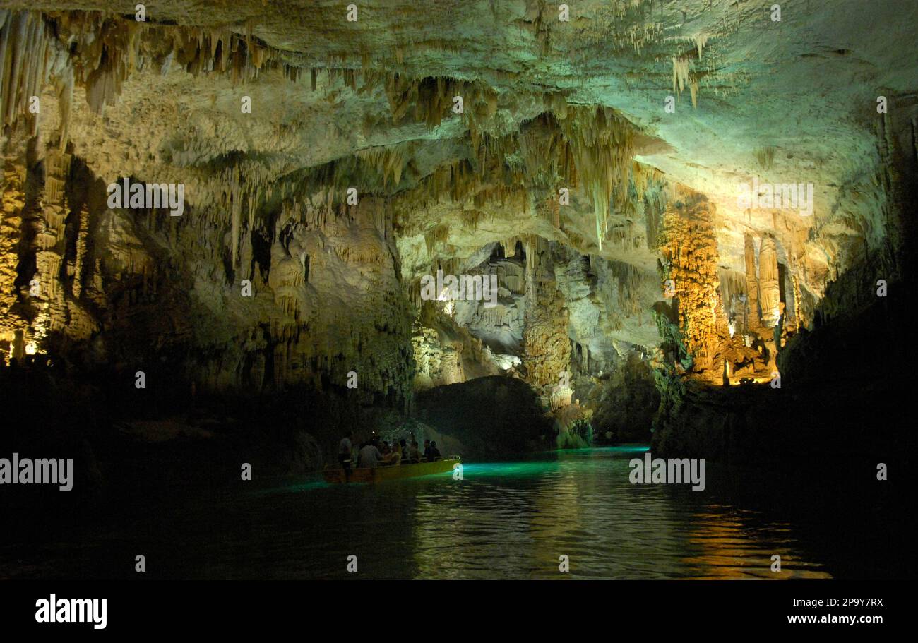 Journalists take a boat tour in the lower cave of the Jeita Grotto ...