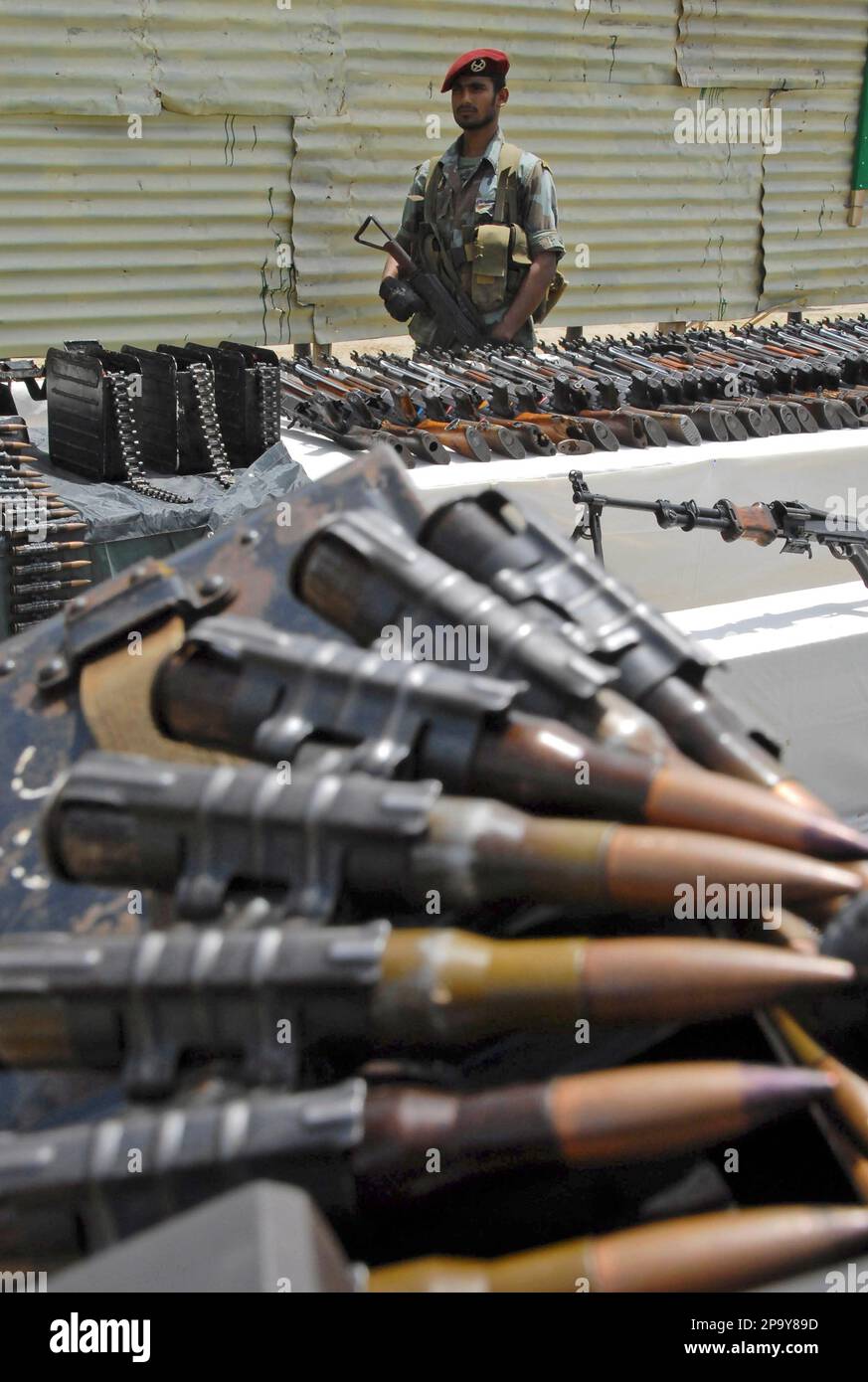 Sri Lankan army soldier stands guard next to weapons claimed to have ...