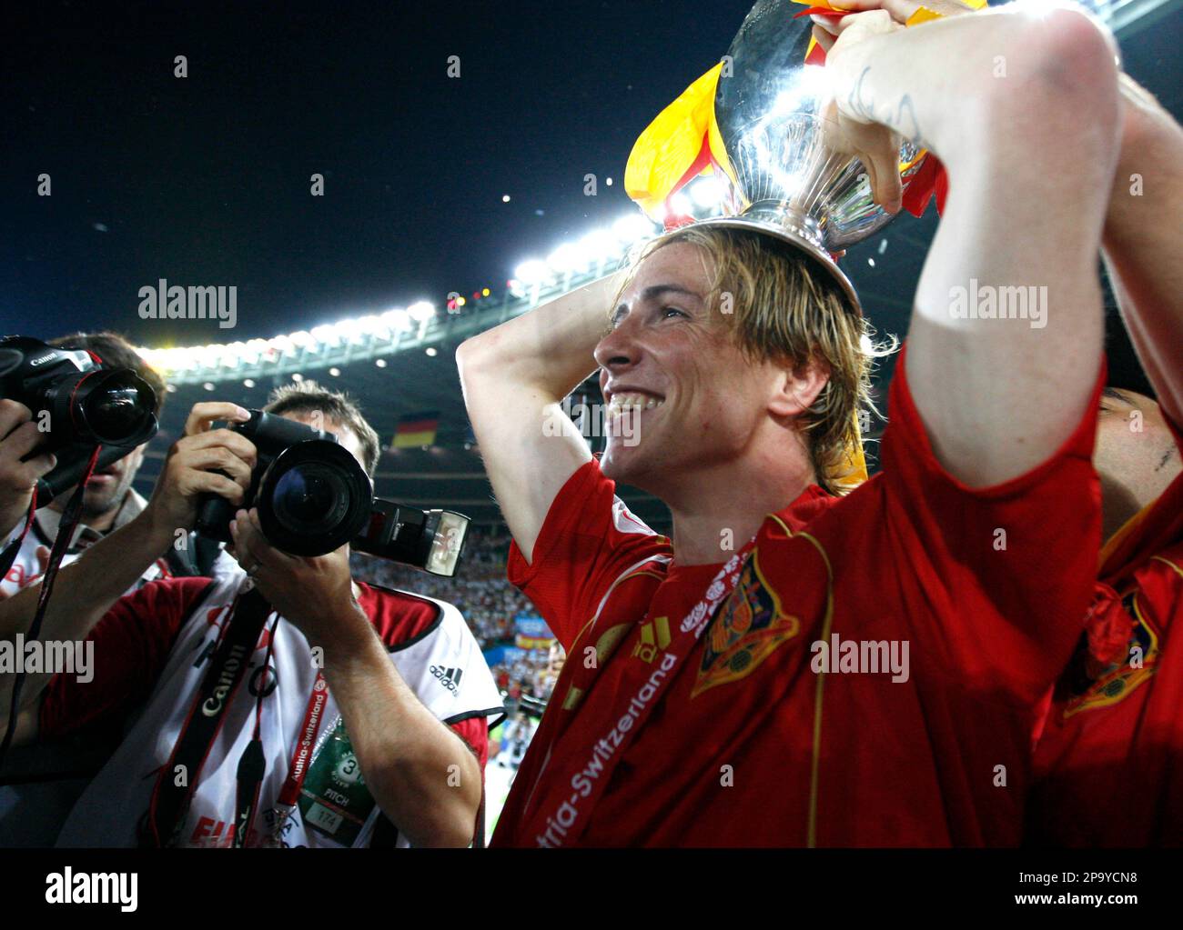 Spain's Fernando Torres holds the trophy upon his head as he celebrates ...