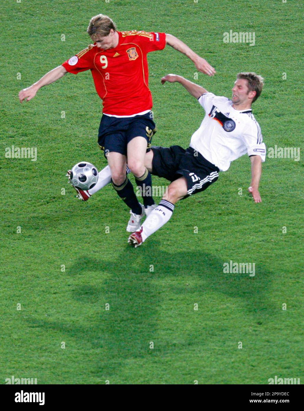Spain's Fernando Torres, left, is tackled by Germany's Thomas ...