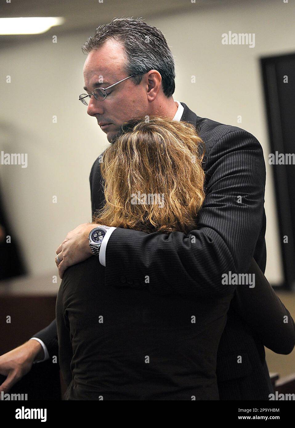 Carl Schiller, top, hugs his wife Meredith following the sentencing of ...