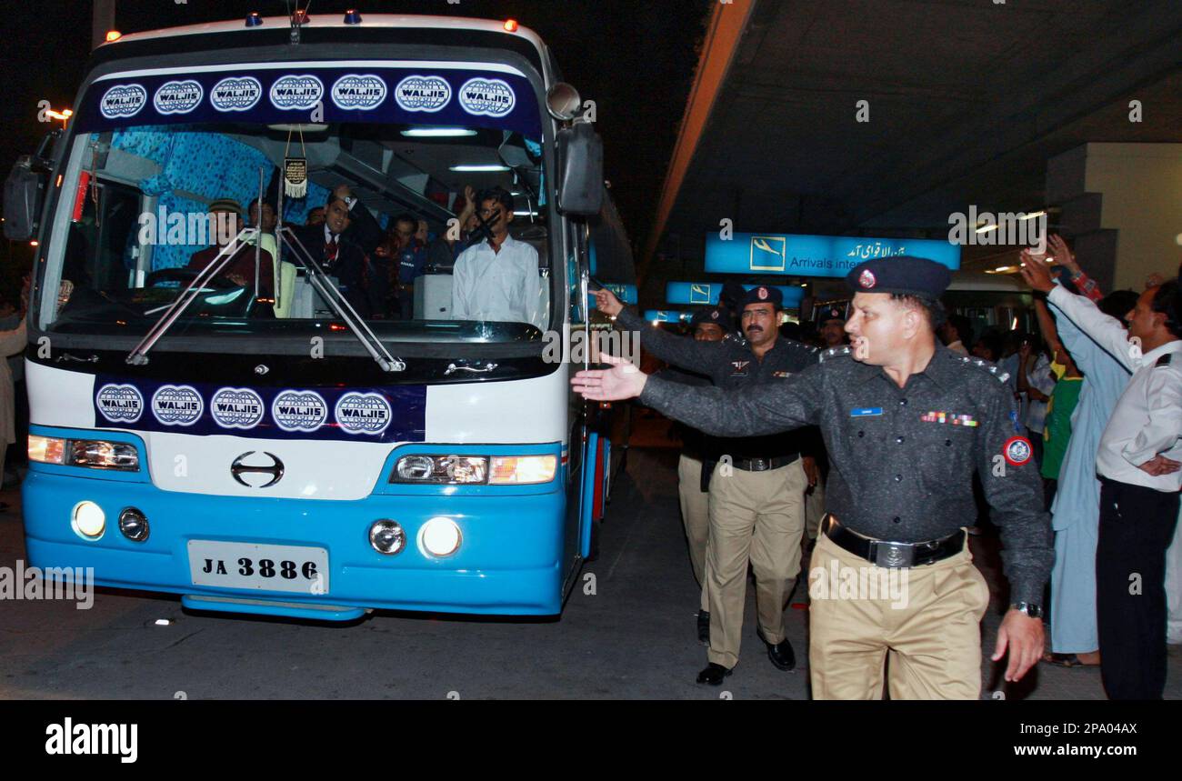 Pakistani police officers provide security to a bus carrying Indian ...