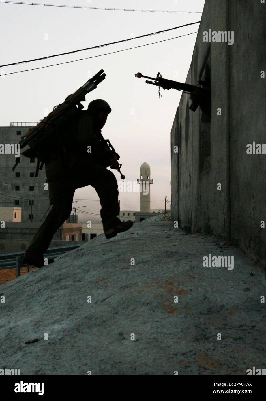 Israeli soldiers take position during an urban warfare exercise at an ...