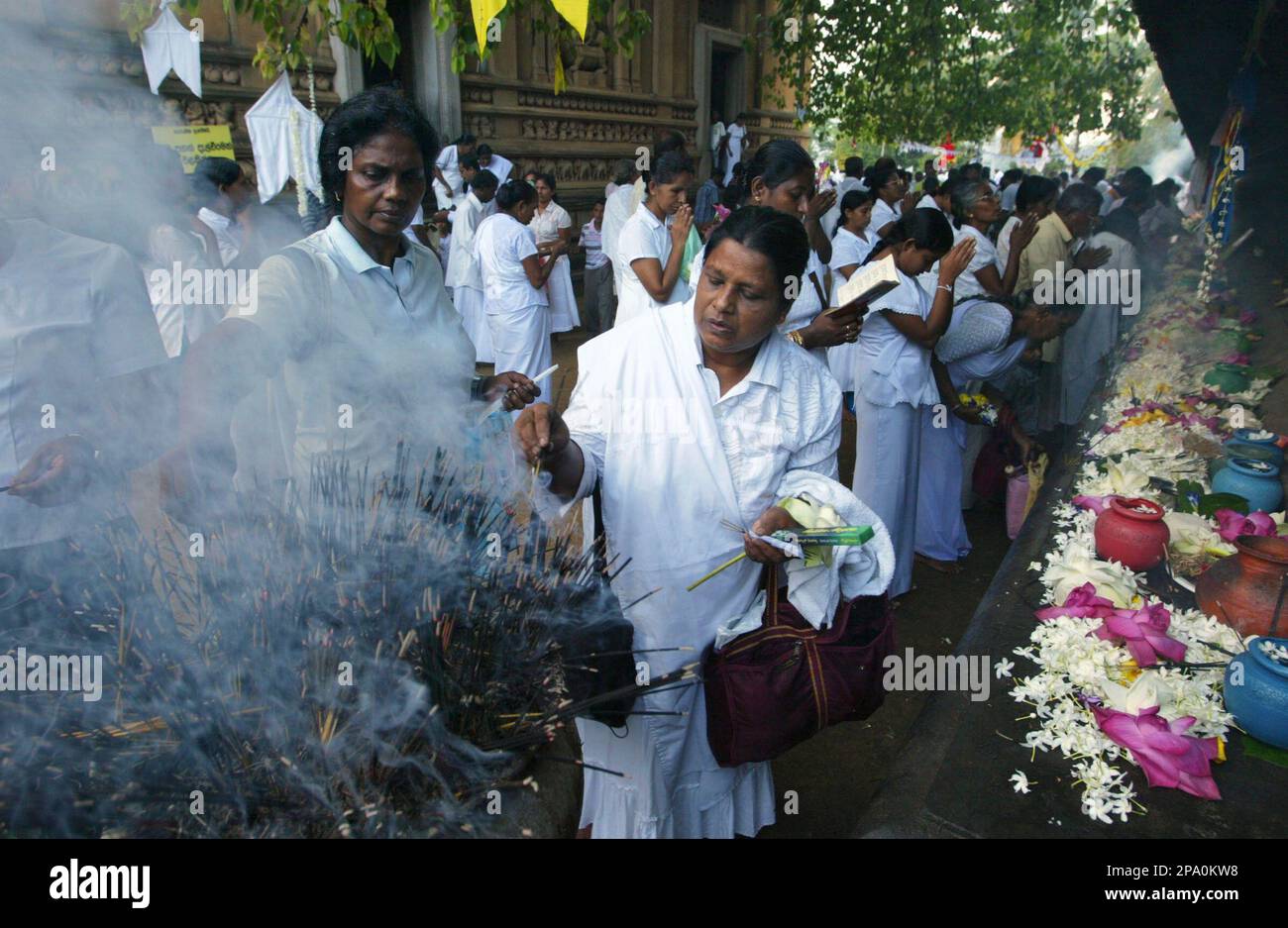 Sri Lankan Buddhist devotees perform rituals during Poson full moon day ...