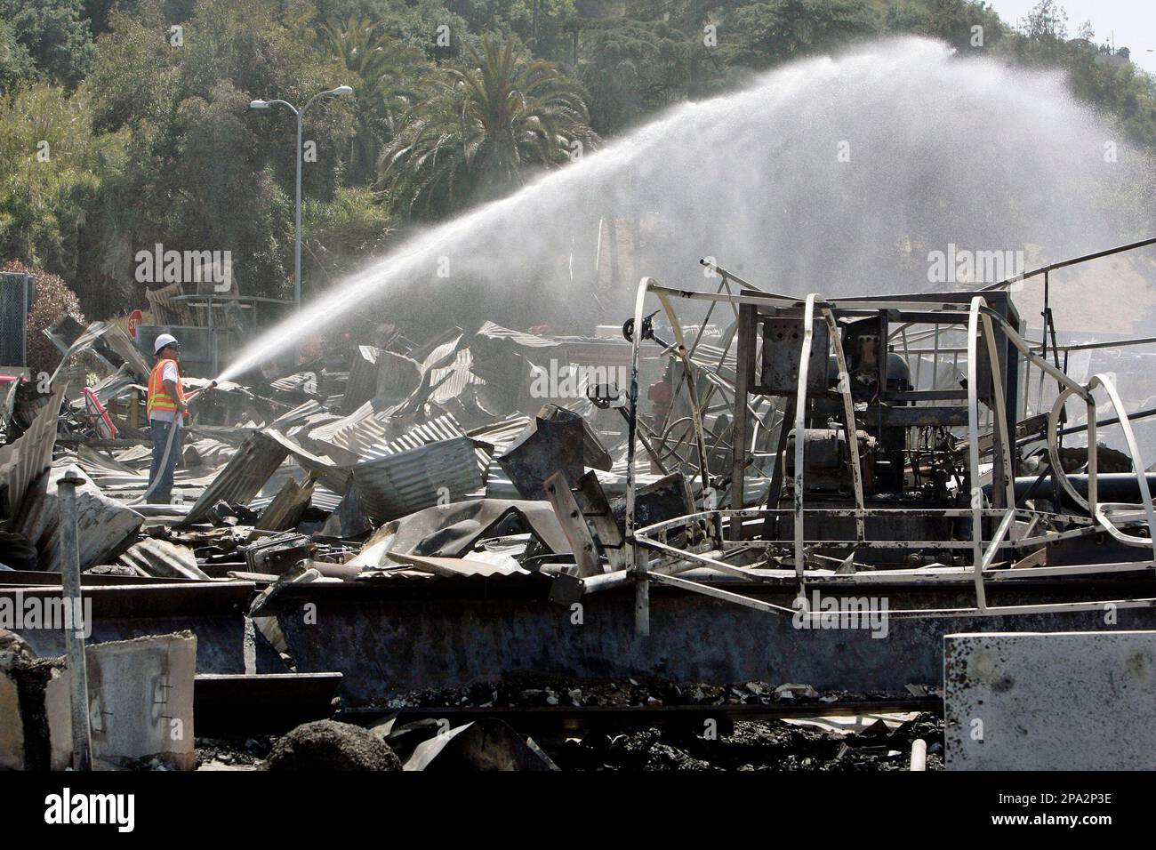 Ted Wayman, a Universal Studios' worker, hoses down the area outside ...