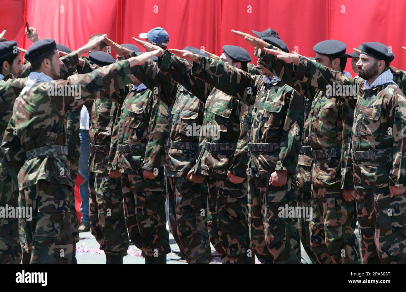 Hezbollah fighters, salute upon the arrival of Nasim Nisr, a Lebanese ...