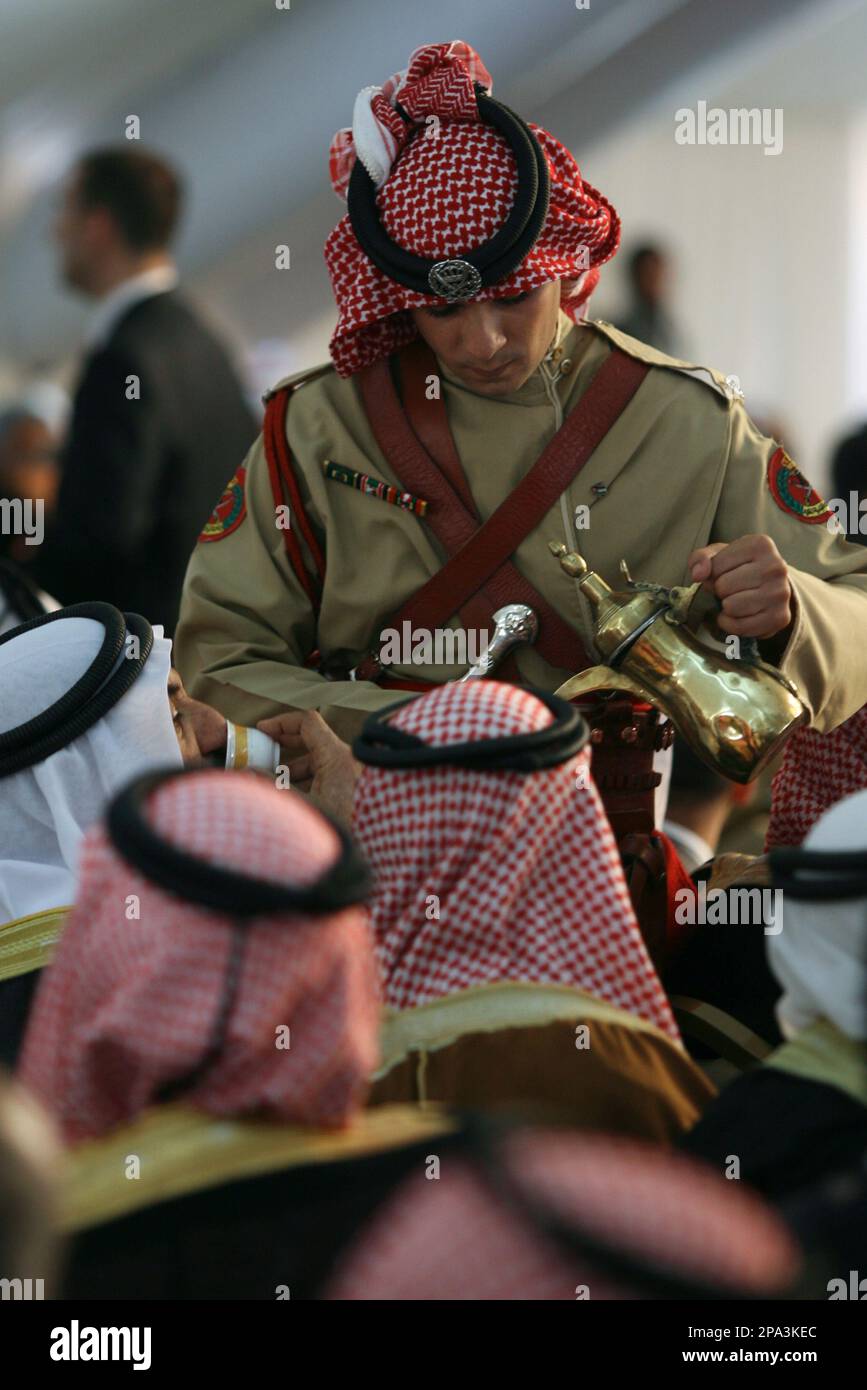 Jordanian man wears traditional costume while he pours a traditional ...