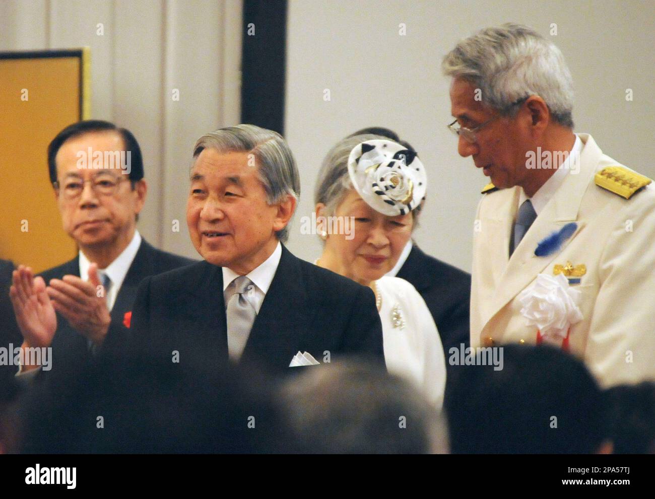 Japanese Emperor Akihito, 2nd from left, and Empress Michiko are guided ...