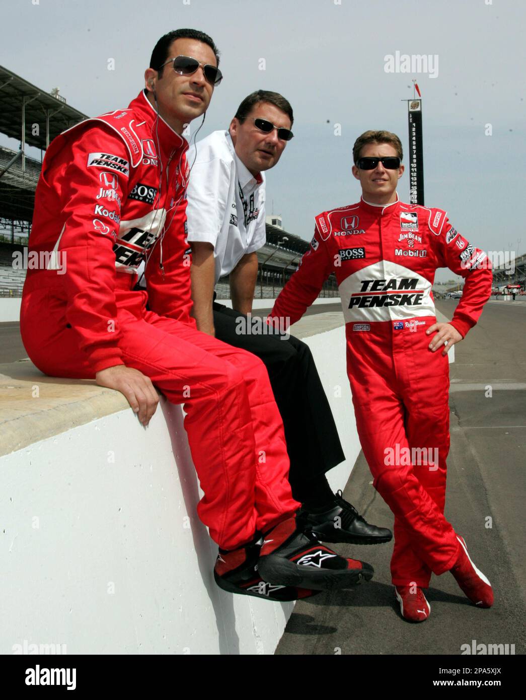 Race driver Helio Castroneves, of Brazil, left, and teammate Ryan Briscoe, of Australia, right ...
