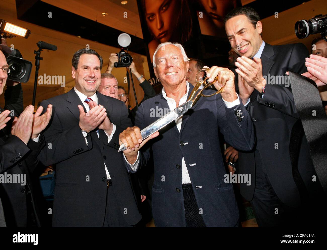 Giorgio Armani, center, makes an appearance at Saks Fifth Avenue ...