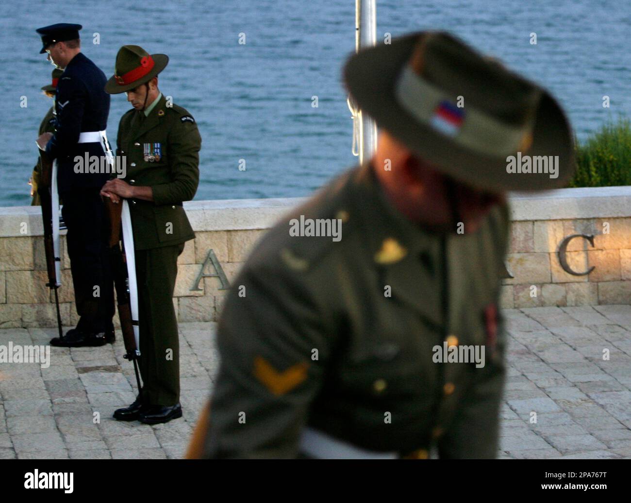 Australian and New Zealand soldiers stand guard during a dawn ceremony ...