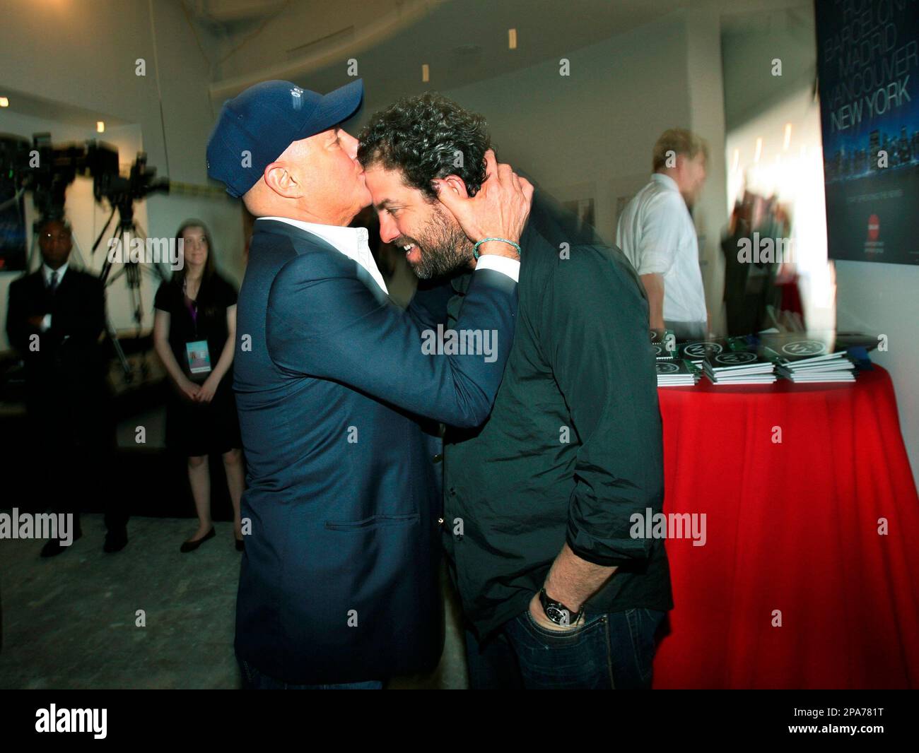 Investor Ronald O. Perelman, left, kisses film director Brett Ratner on ...