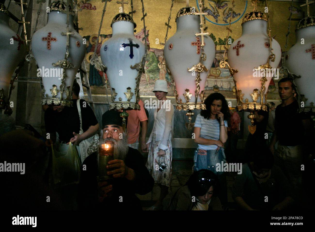 Orthodox Pilgrims gather at the Anointing Stone before the Washing of ...
