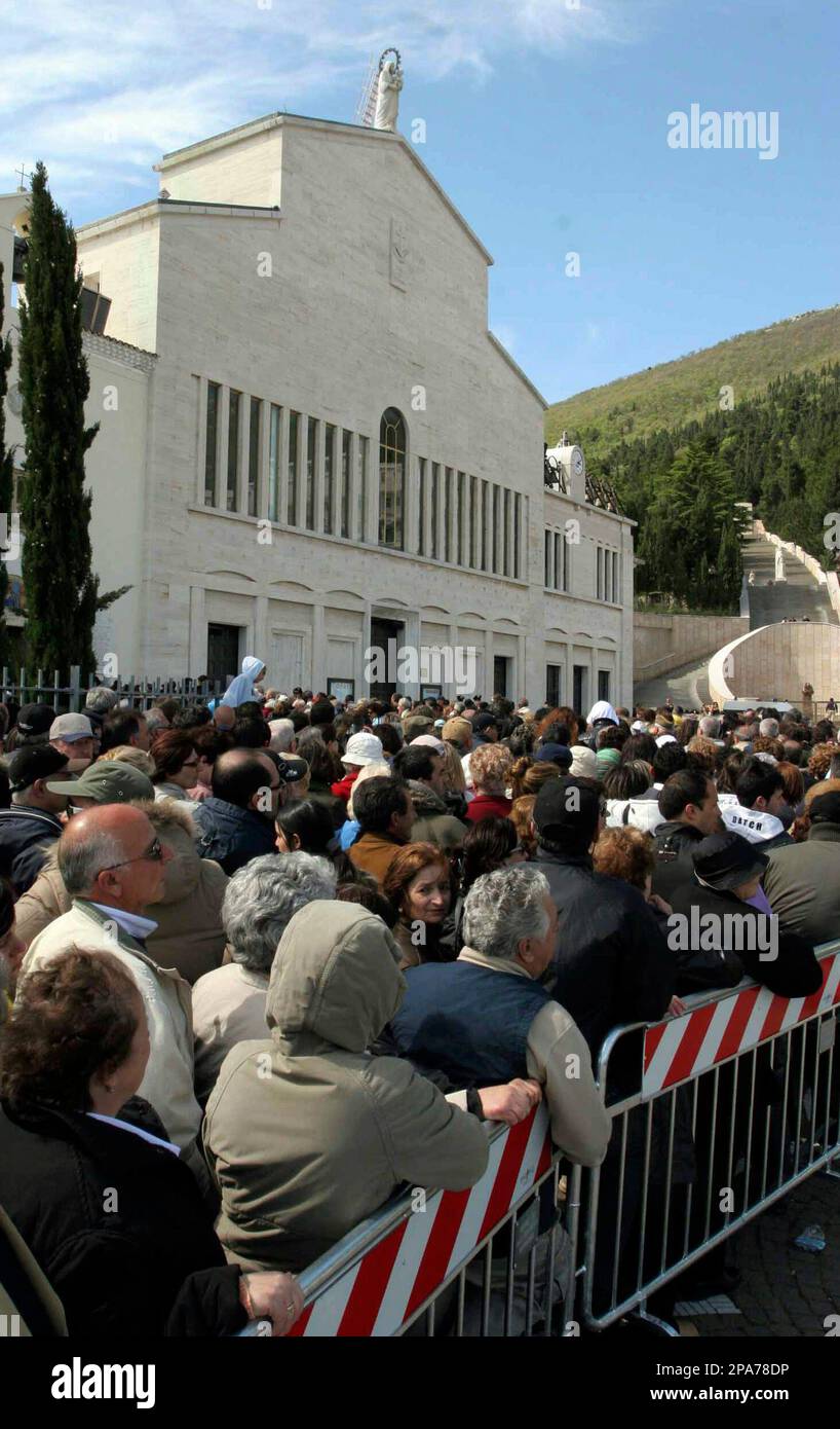 People queue outside the church of Santa Maria delle Grazie in San ...