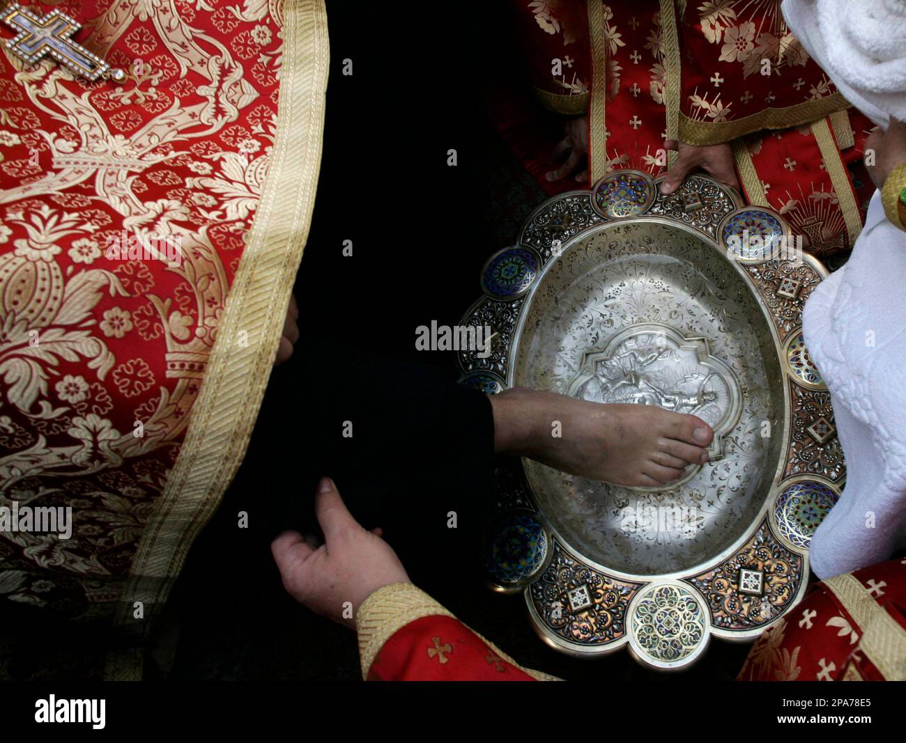 Greek Orthodox Patriarch of Jerusalem Theofilos III, not seen, washes a ...