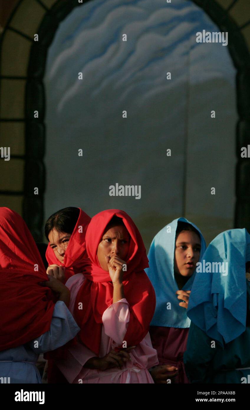Women, wearing costumes, take part in a reenactment of the crucifixion ...