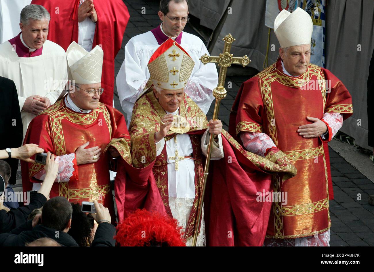 Pope Benedict XVI holds his papal staff as he walks in procession prior ...