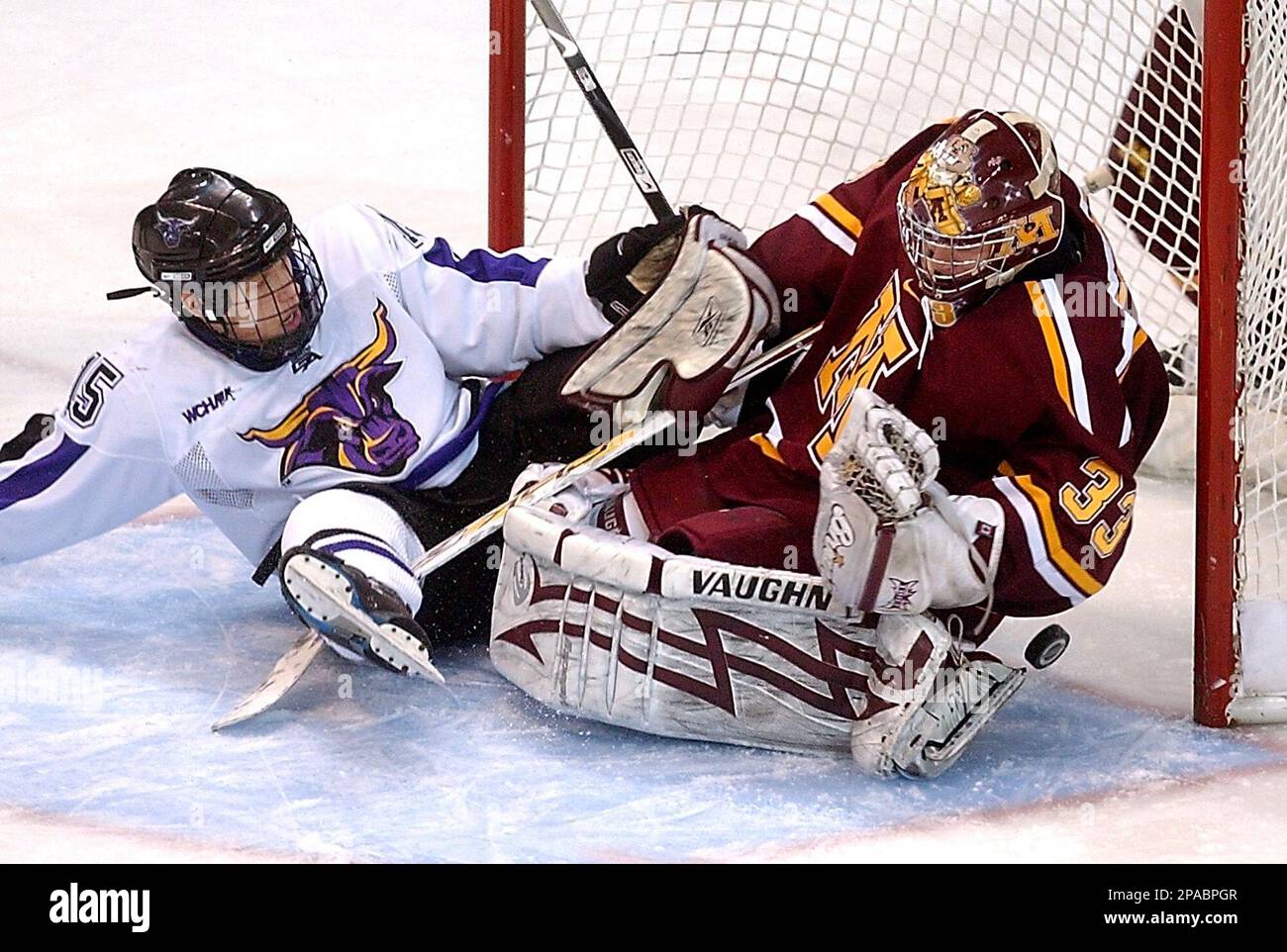 Minnesota State-Mankato's Jerad Stewart collides with Minnesota goalie ...