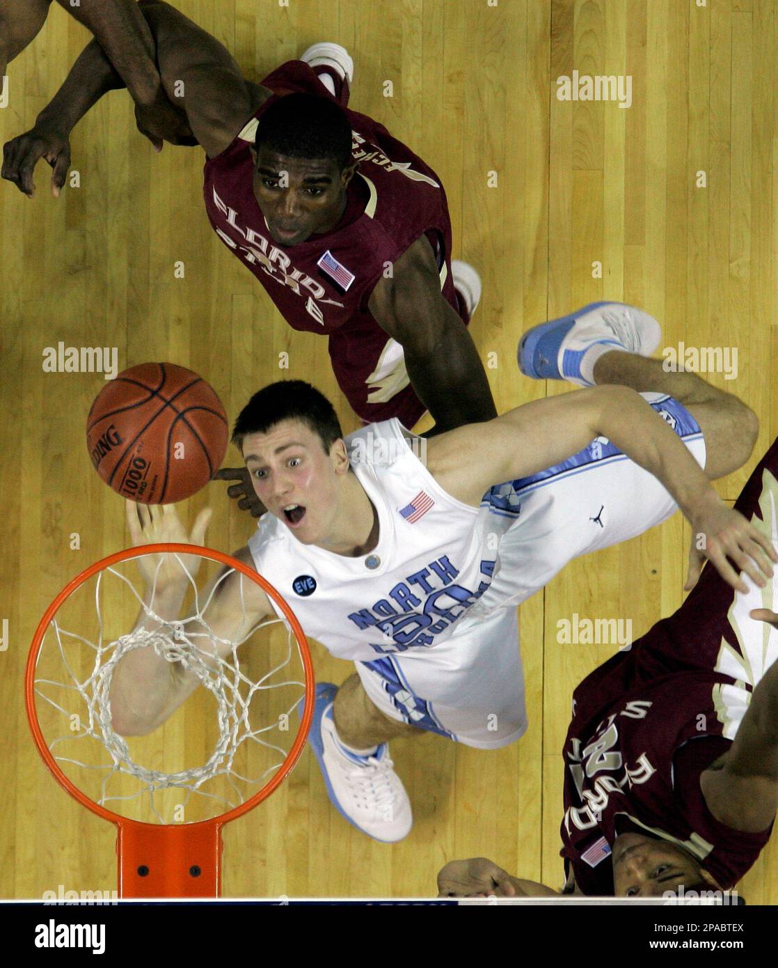 North Carolina's Tyler Hansbrough, center, shoots between Florida State ...