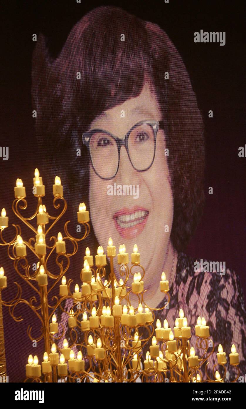 A huge TV screen shows the picture of the late actress Lydia Sum, a ...