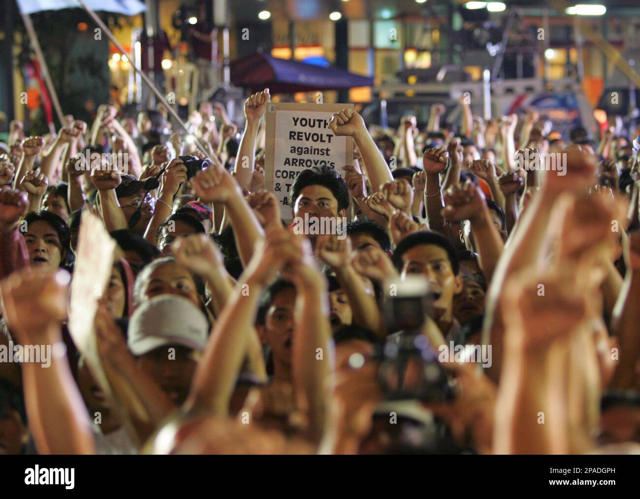Protesters raise their clenched fists as they shout slogans during a ...