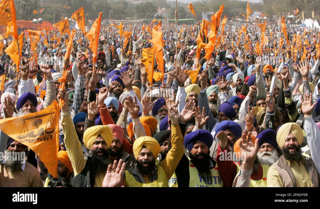Supporters of Shiromani Akali Dal raise slogans as they listen to a ...