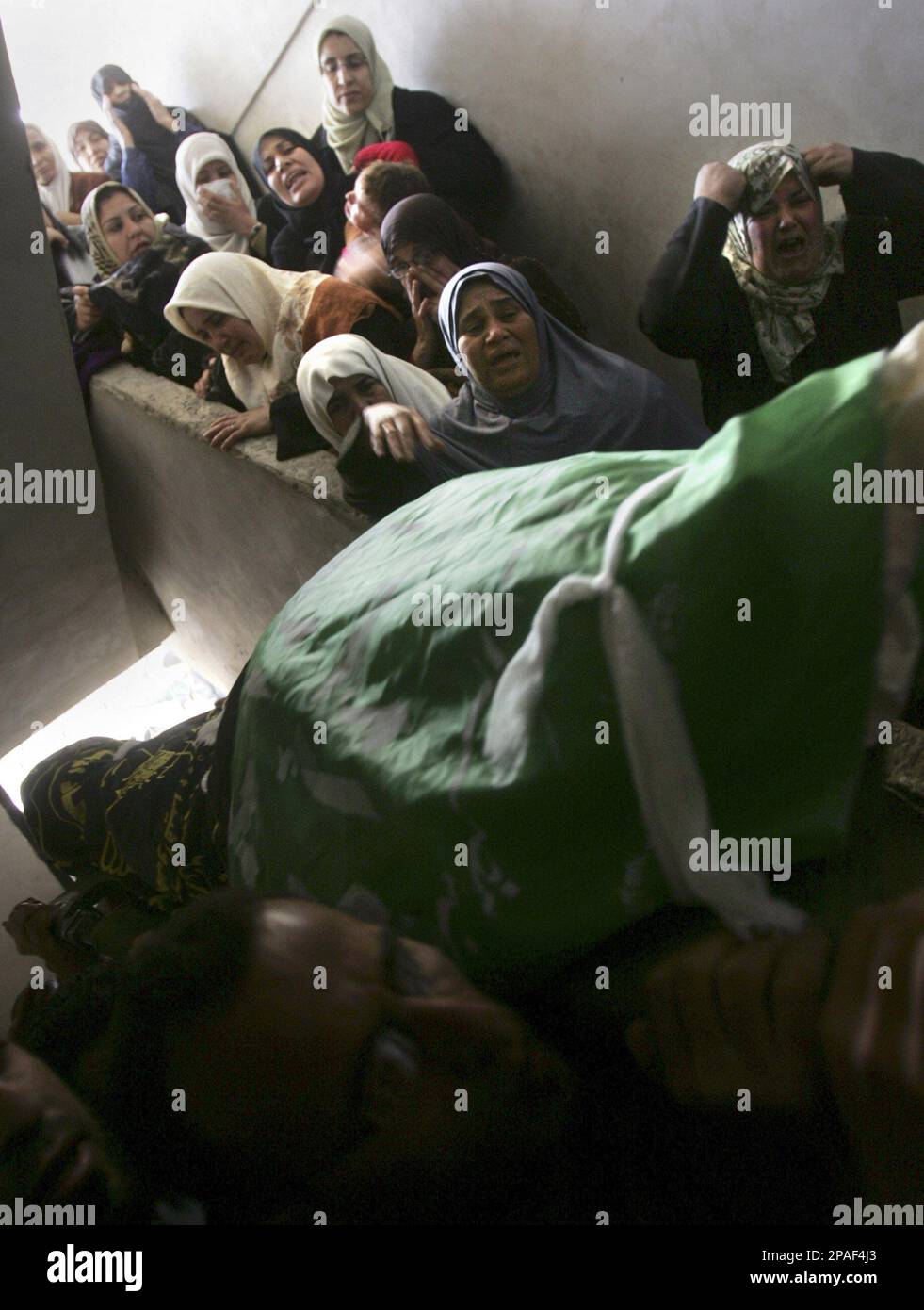 Palestinian relatives of Islamic Jihad leader Ayman Atallah Fayed react at the family house ...