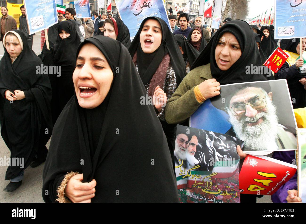 Holding posters of Iranian supreme leader Ayatollah Ali Khamenei, right ...