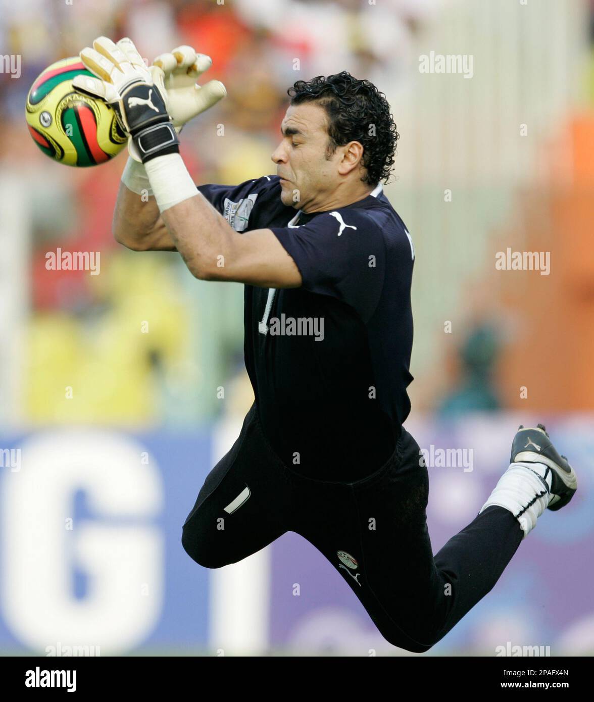 Egypt's goalkeeper Essam El-Hadary saves a free kick by Cameroon's Geremi Njitap, unseen, during ...