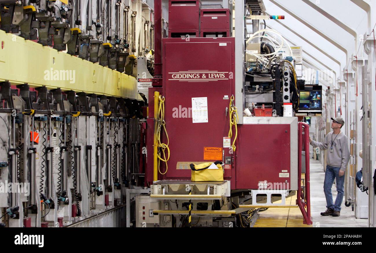 Operator Monty Miller is dwarfed by an Automated Spar Assembly Tool ...