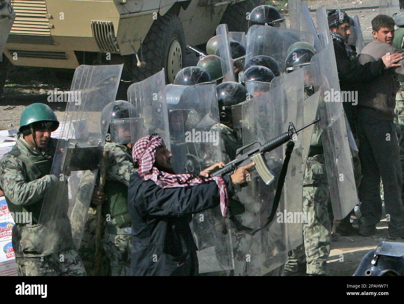 A Palestinian Hamas militant waves his automatic rifle in the air ...