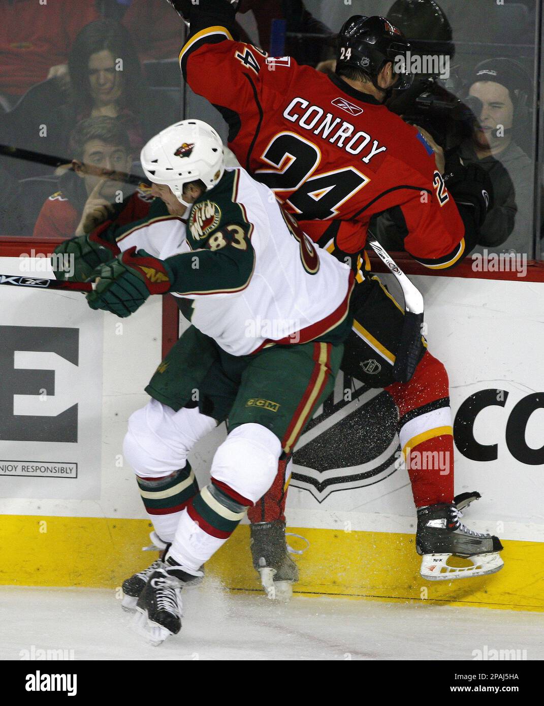 Minnesota Wild's Matt Foy, left, checks Calgary Flames' Craig Conroy ...