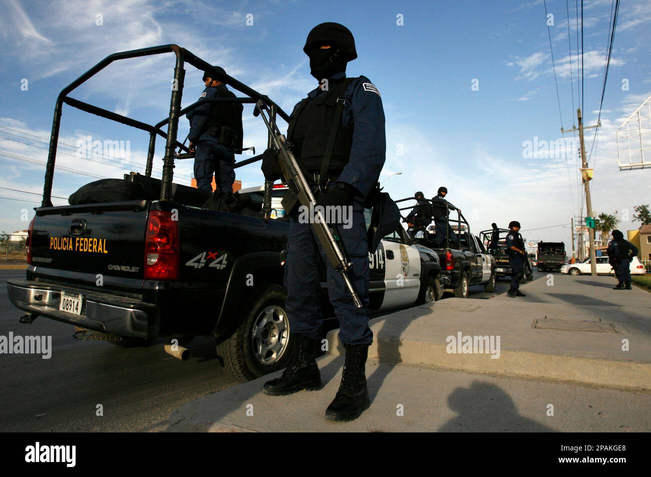 Mexican Federal Police stand guard at a street corner in the border ...