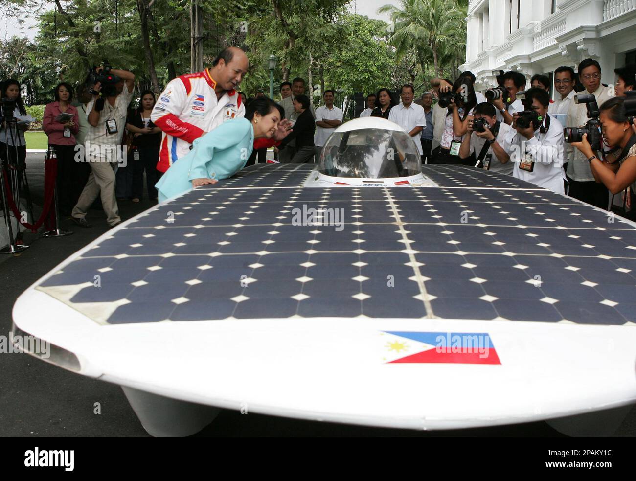 Philippine President Gloria Macapagal Arroyo, center, examines the ...
