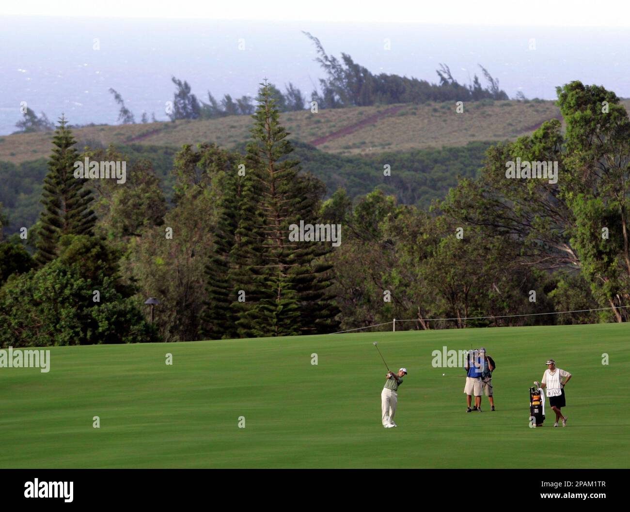 Mike Weir, left, of Canada, hits from the 15th fairway of the ...