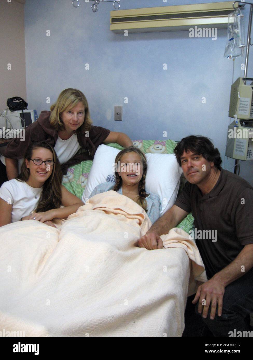 Francesca Lewis, 12, center, poses for a picture with her parents ...
